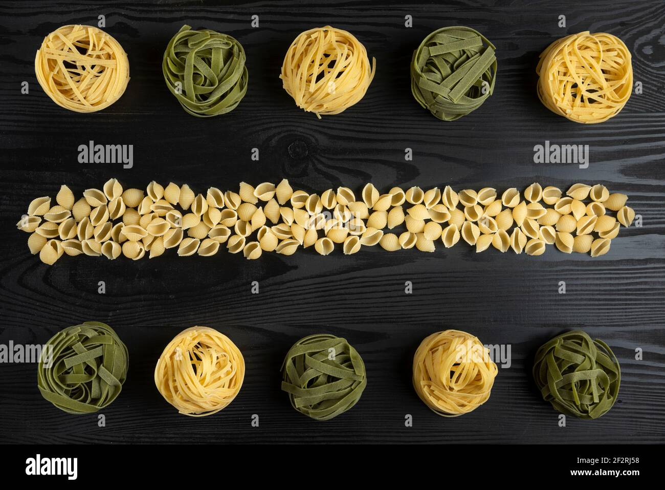 Italian pasta varieties on the black table Stock Photo - Alamy