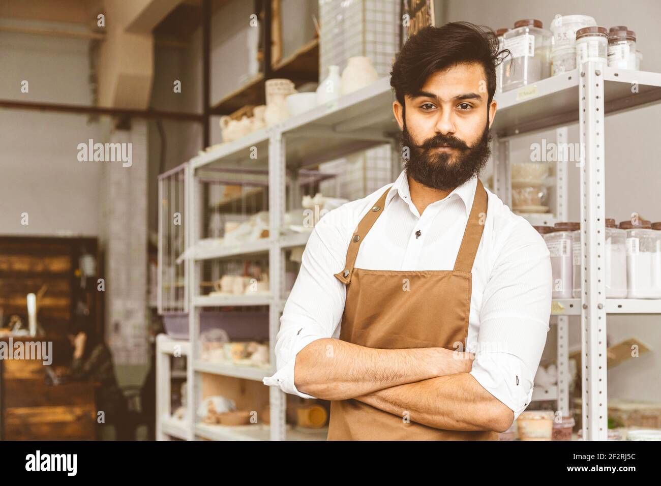 Portrait of a young attractive businessman craftsman with a beard and ...