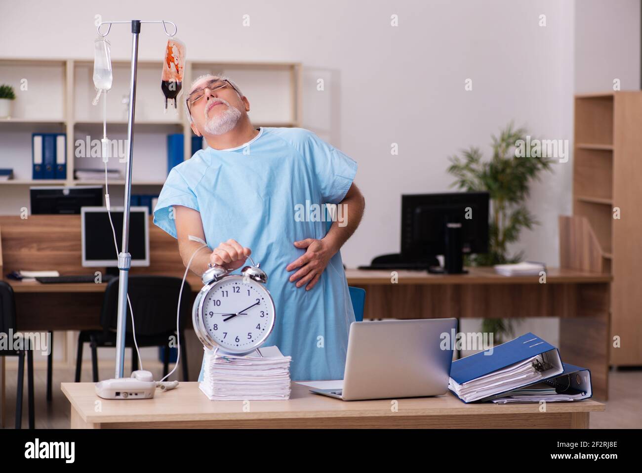 Old businessman employee in blood transfusion concept Stock Photo - Alamy