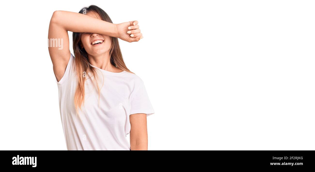 Beautiful Caucasian Woman Wearing Casual White Tshirt Covering Eyes