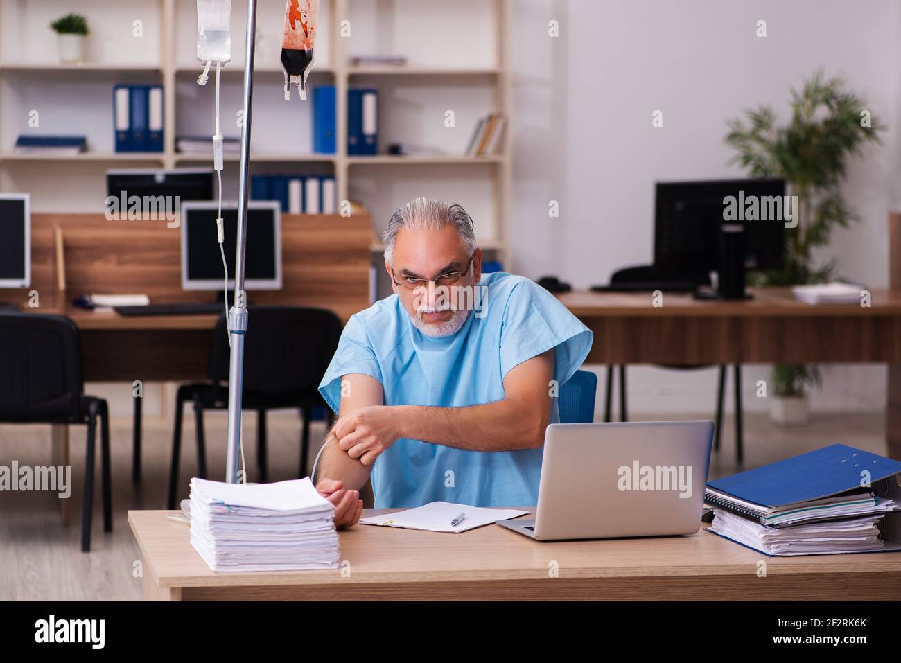 Old businessman employee in blood transfusion concept Stock Photo - Alamy