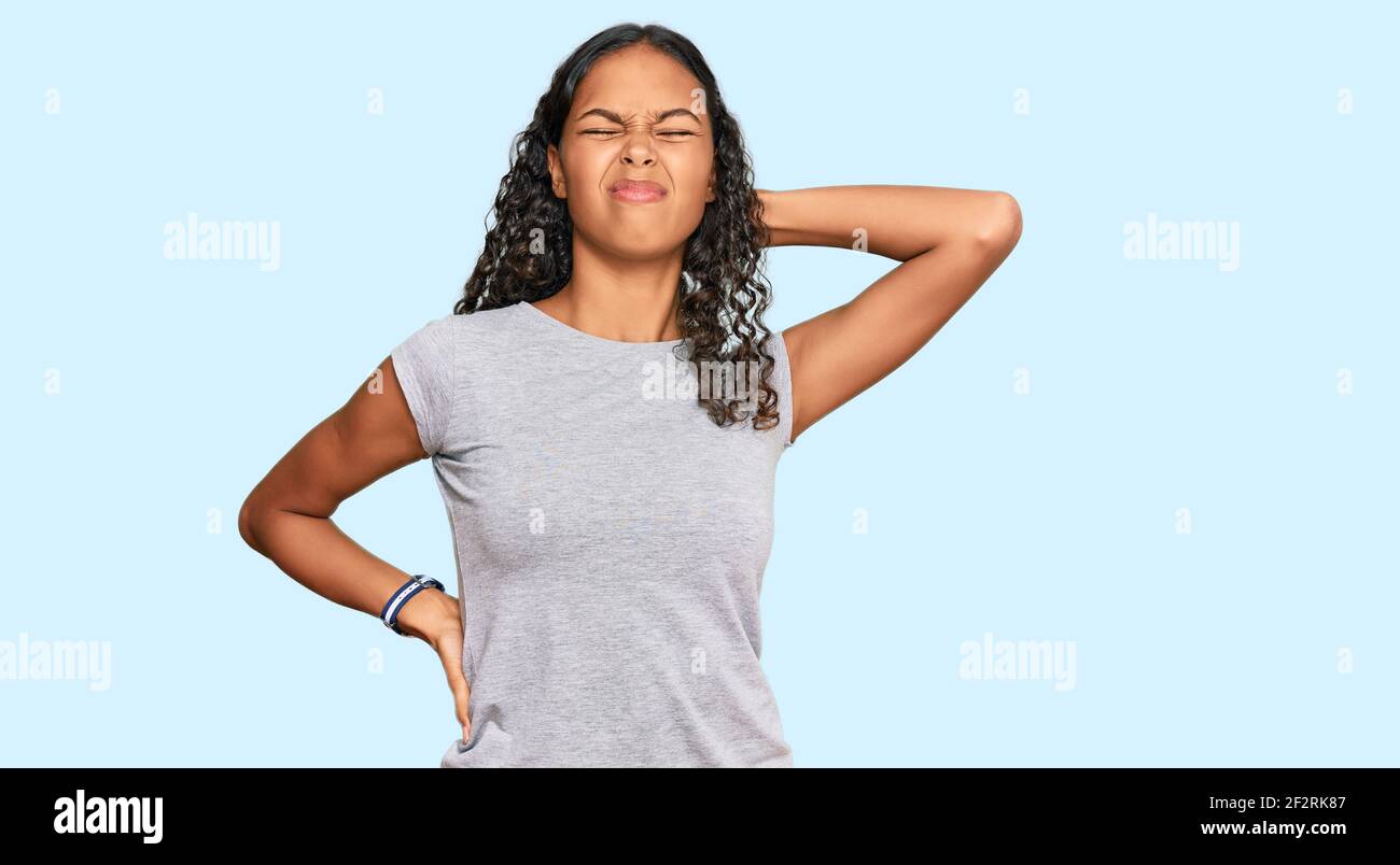 Young african american girl wearing casual clothes suffering of neck ...