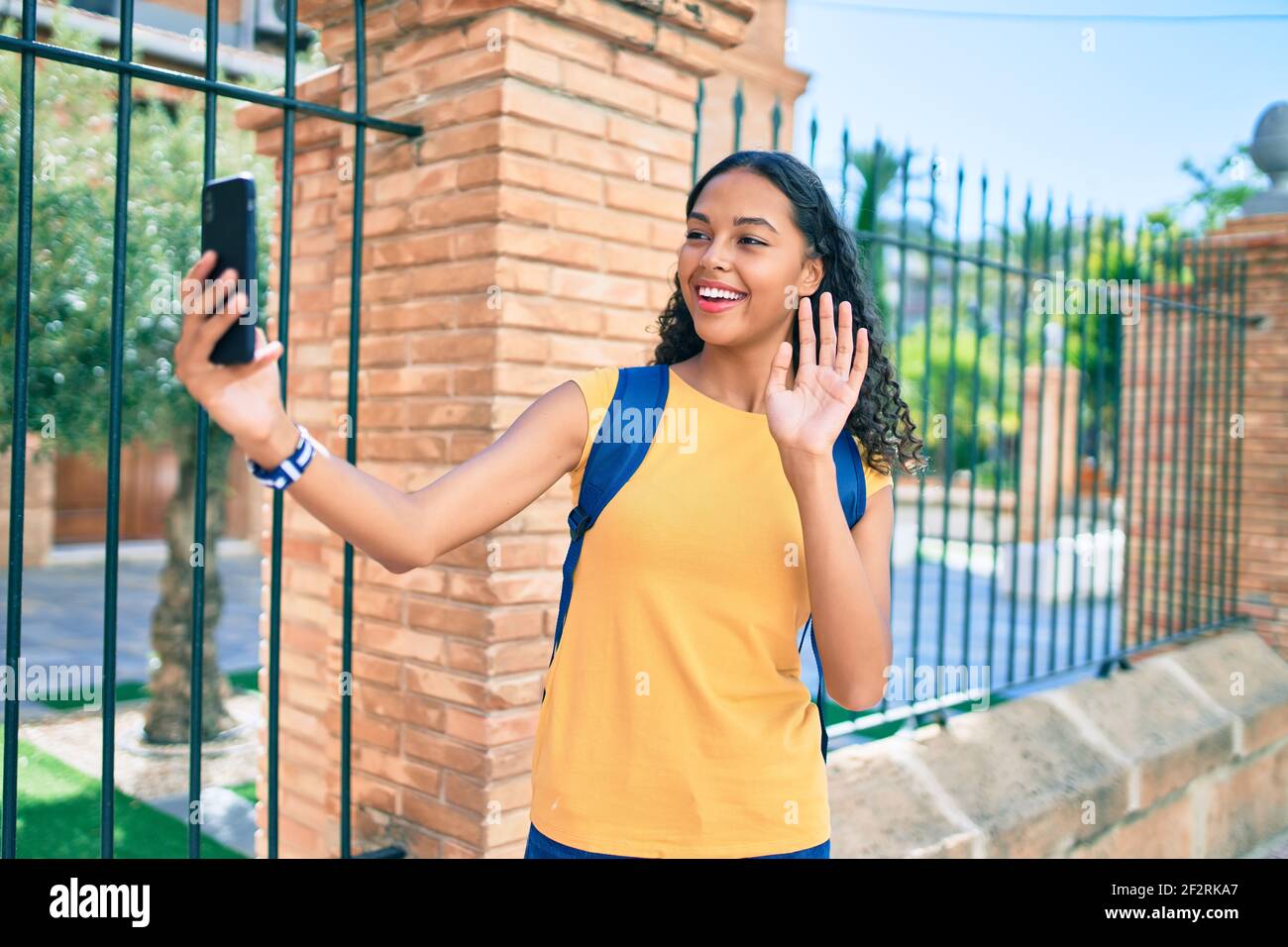 Young african american student girl doing video call using smartphone ...