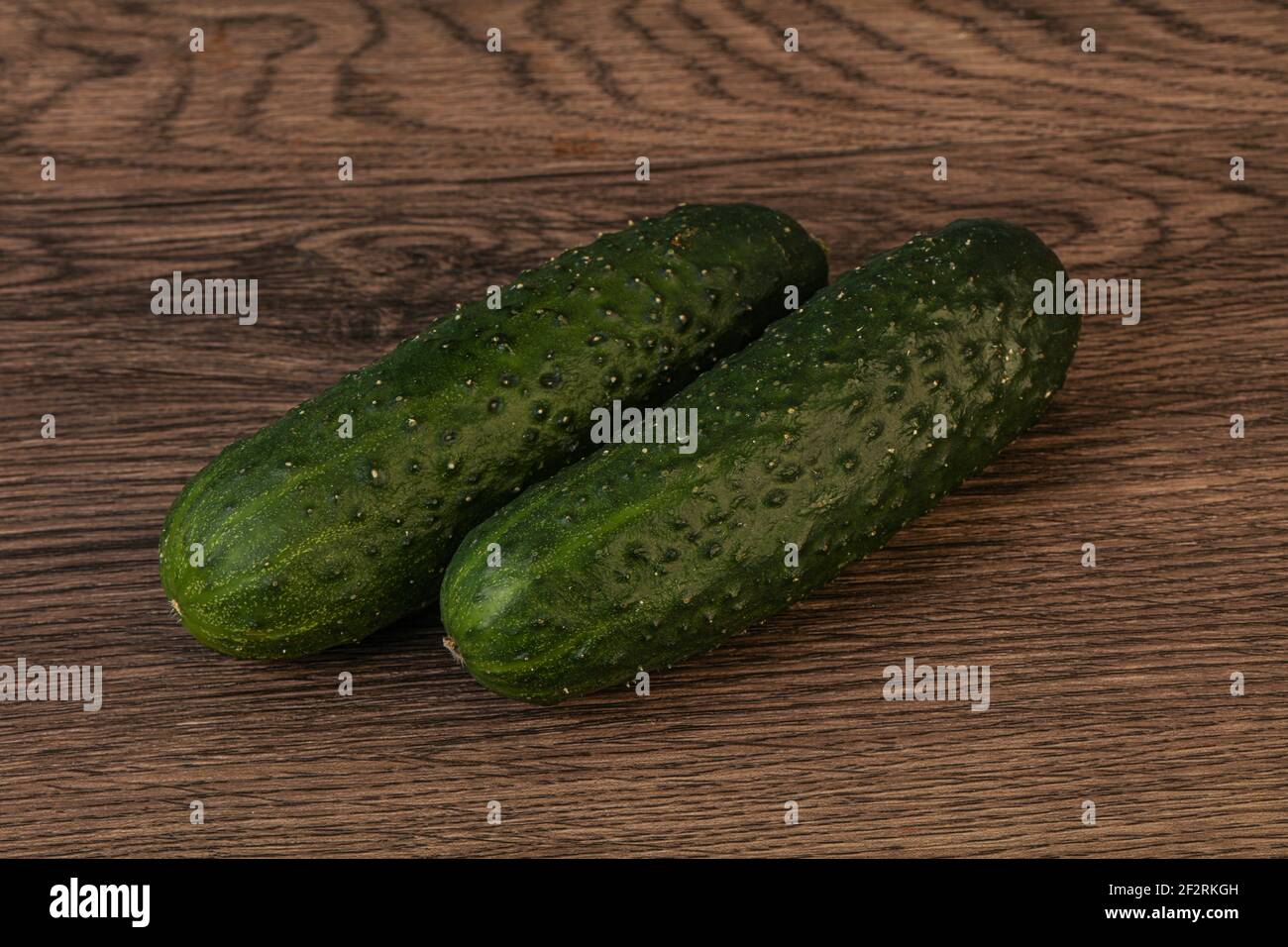 Green fresh two cucumbers over background Stock Photo - Alamy
