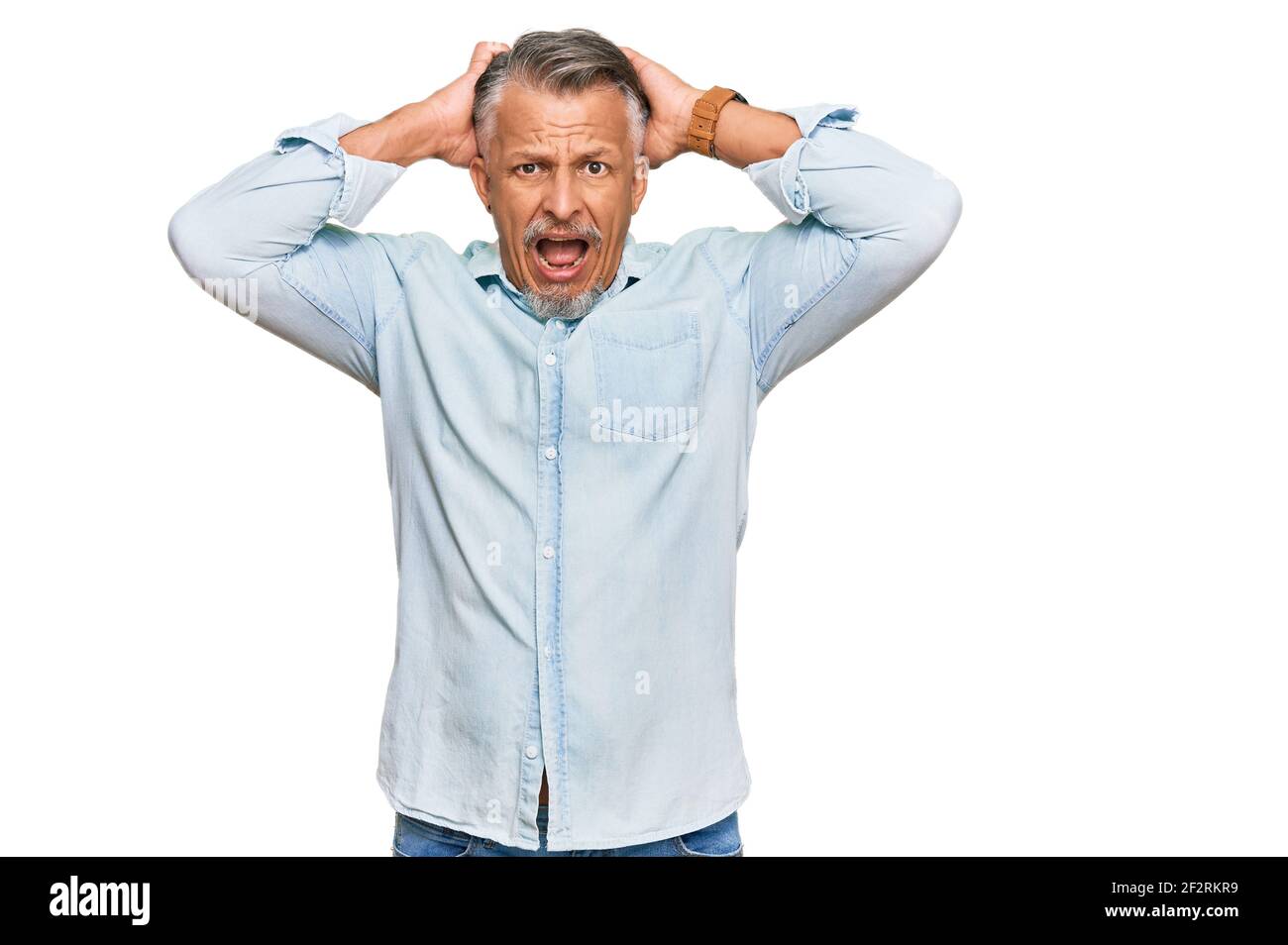 Middle age grey-haired man wearing casual clothes crazy and scared with ...