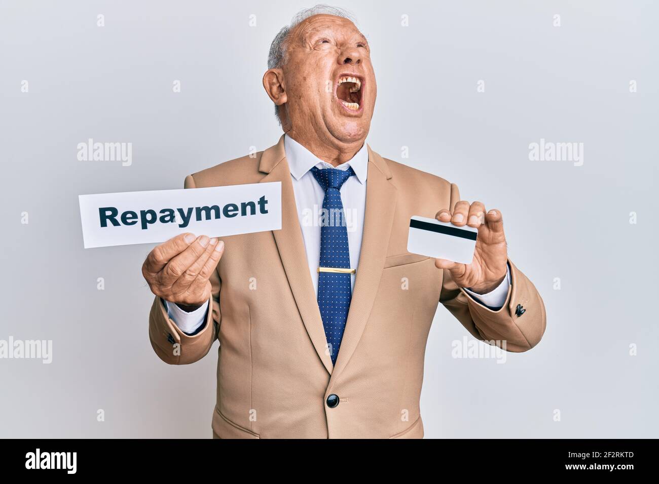 Senior caucasian man holding payment word paper and credit card angry ...