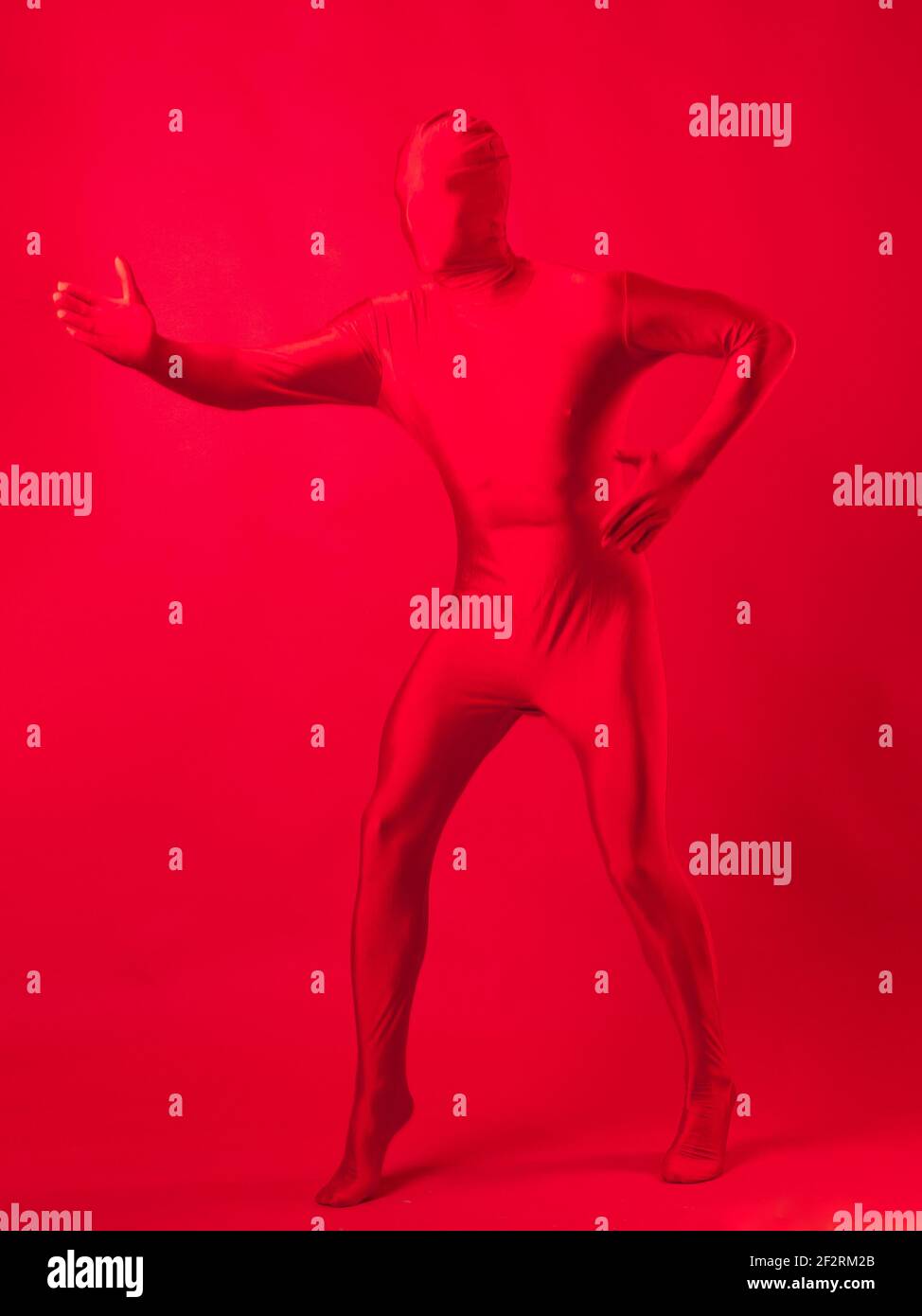 Funny character in a red leotard runs forward. The man in red on a red ...