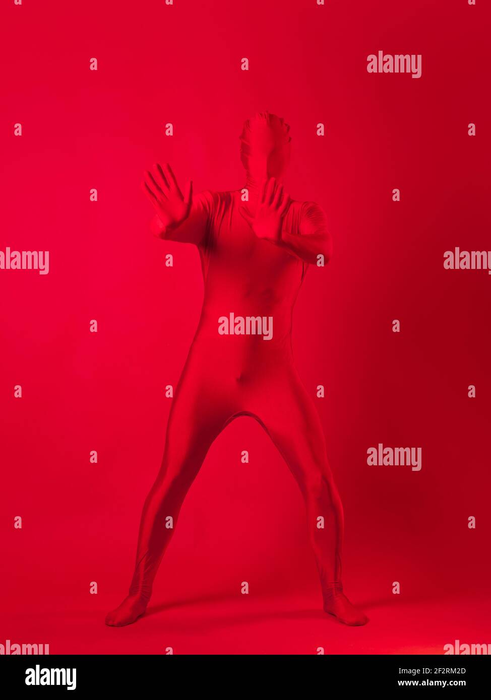 Crazy red man on a red background, figure in a leotard covering the ...