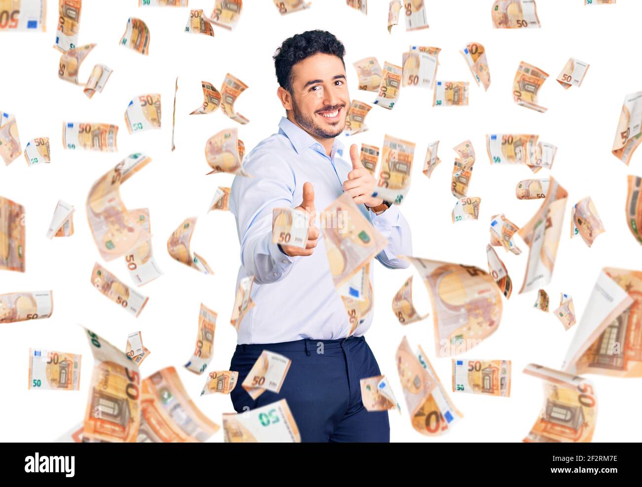 Young hispanic man wearing business clothes pointing fingers to camera ...