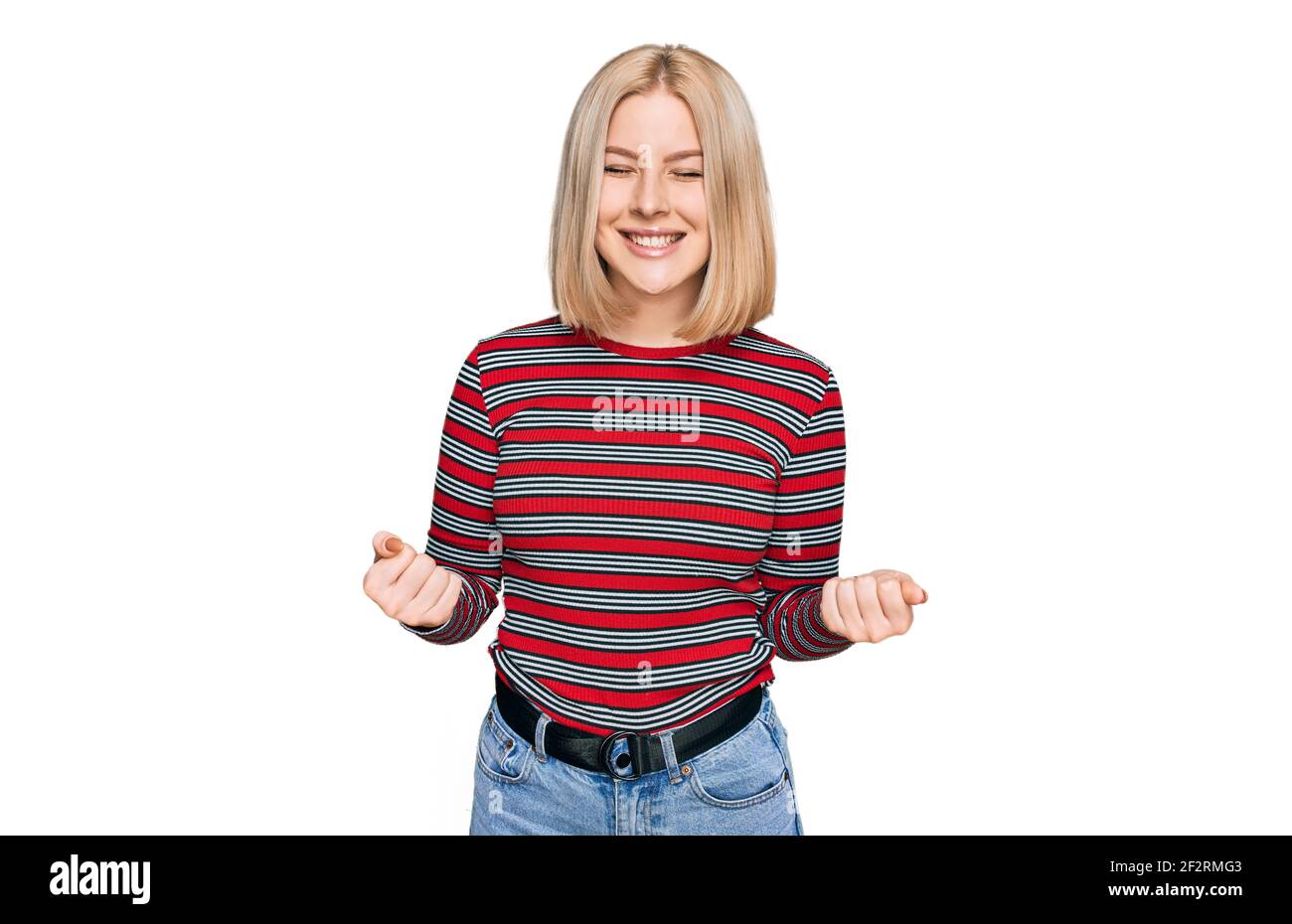 Young blonde woman wearing casual clothes very happy and excited doing ...