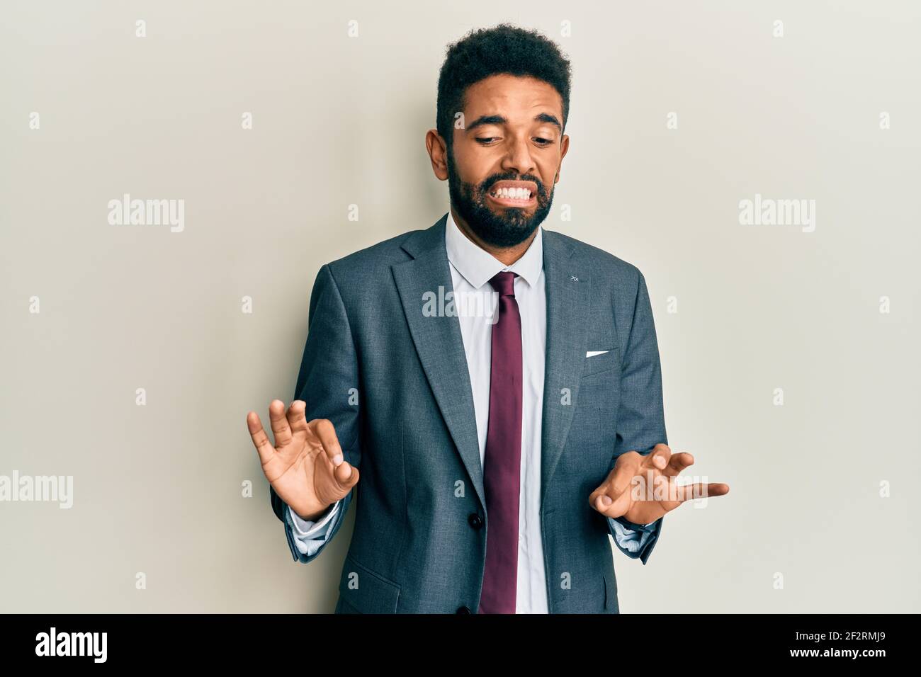 Handsome hispanic man with beard wearing business suit and tie ...