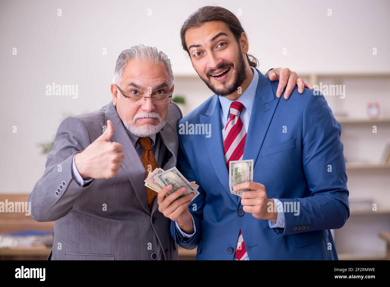 Two employees in remuneration concept Stock Photo - Alamy