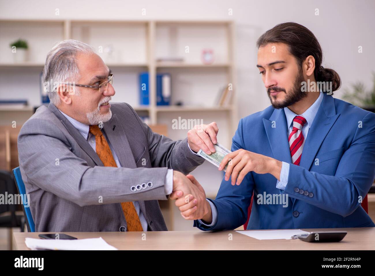 Two employees in remuneration concept Stock Photo - Alamy