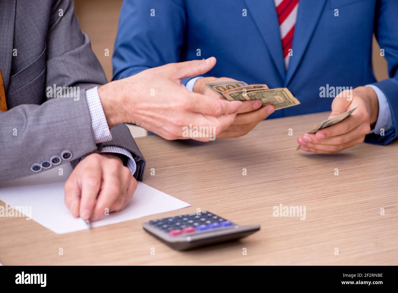 Two employees in remuneration concept Stock Photo - Alamy