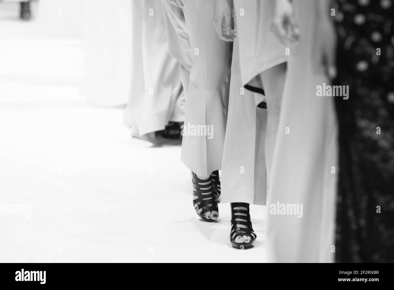 Fashion catwalk runway event, model walking the show finale. Woman legs ...