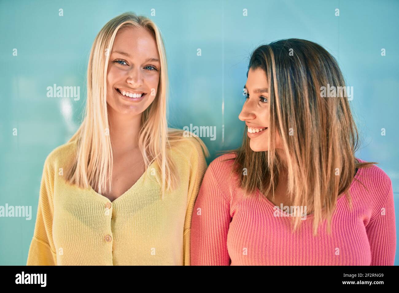 Two beautiful and young girl friends together having fun at the city ...