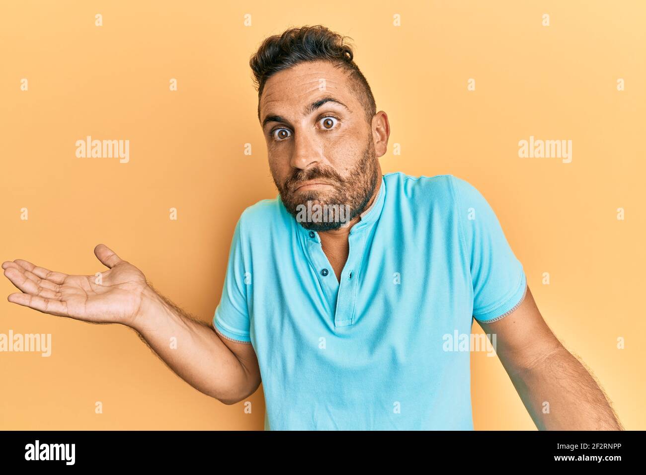 Handsome man with beard wearing casual clothes clueless and confused ...