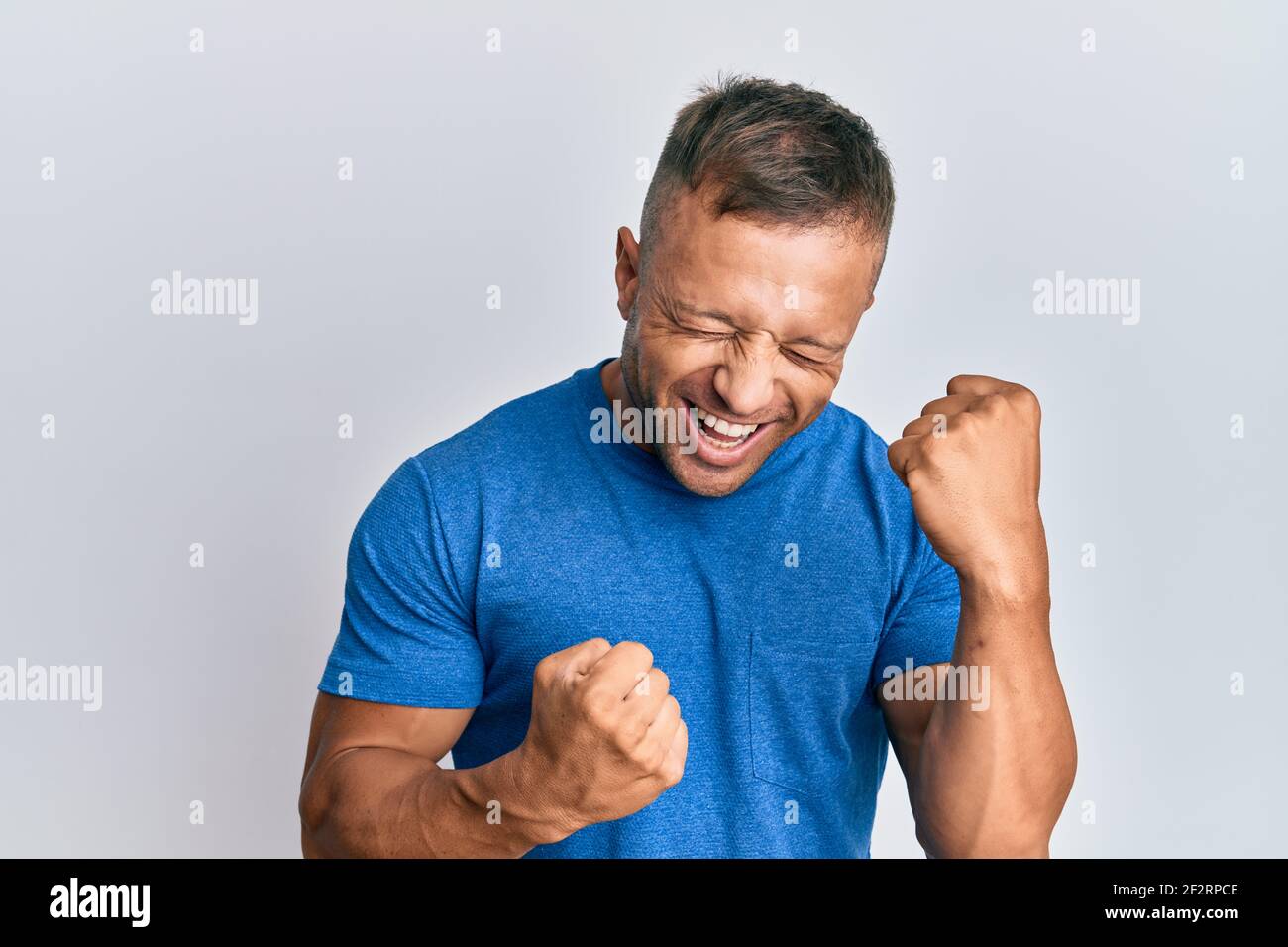 Handsome muscle man wearing casual clothes celebrating surprised and ...