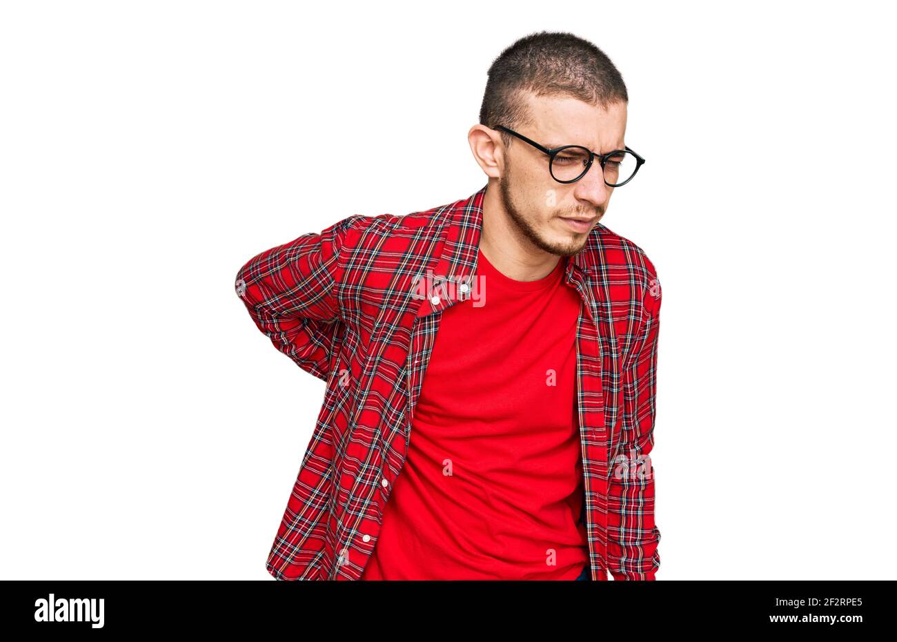 Hispanic young man wearing casual clothes suffering of backache ...