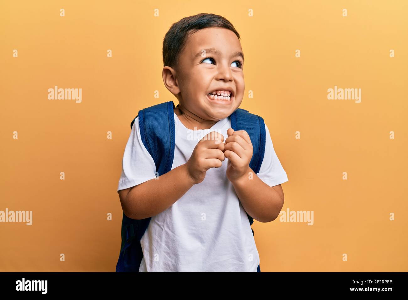 Adorable latin toddler smiling happy wearing student backpack over ...