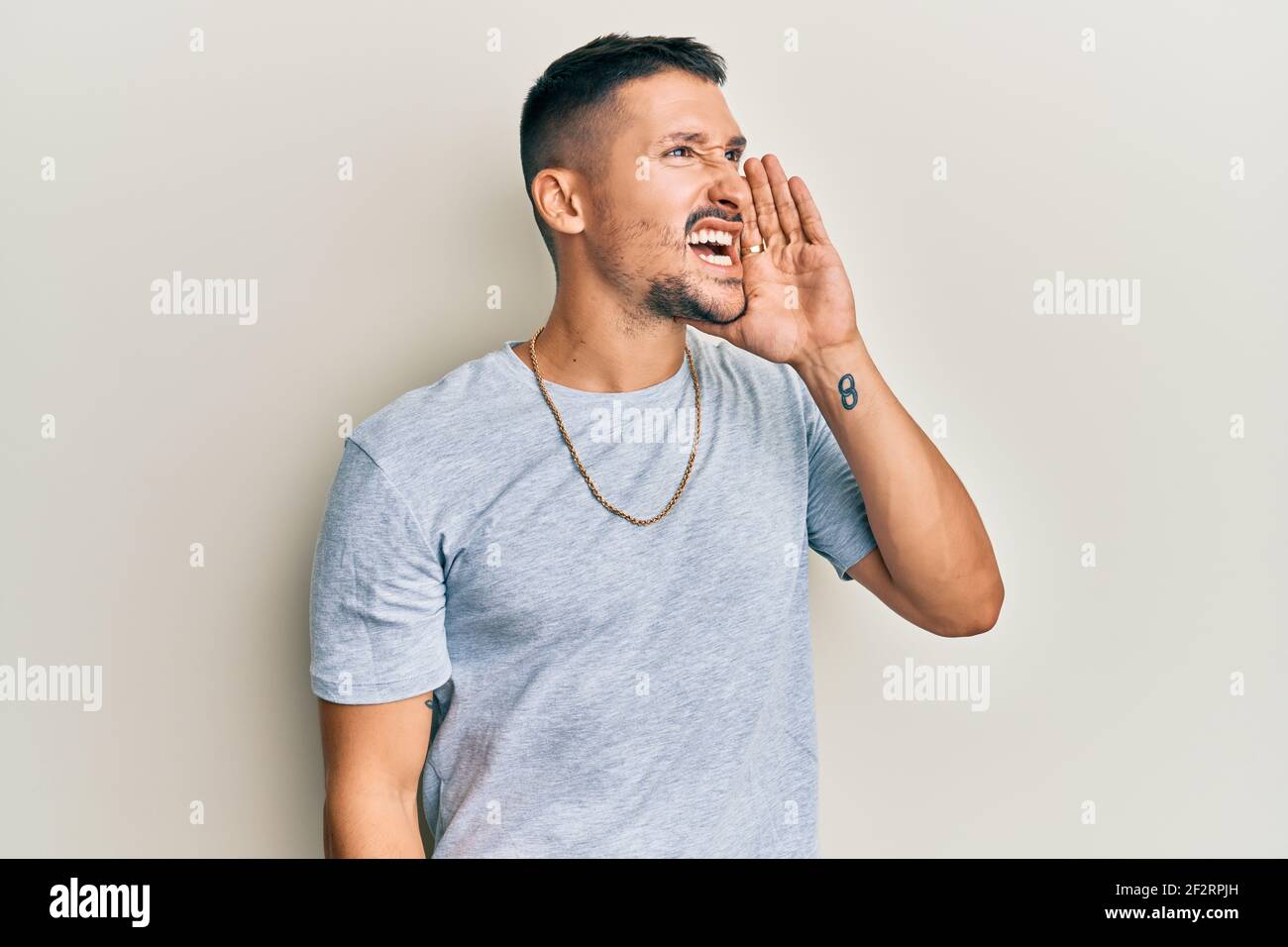 Handsome man with tattoos wearing casual 90s style and gold chain ...