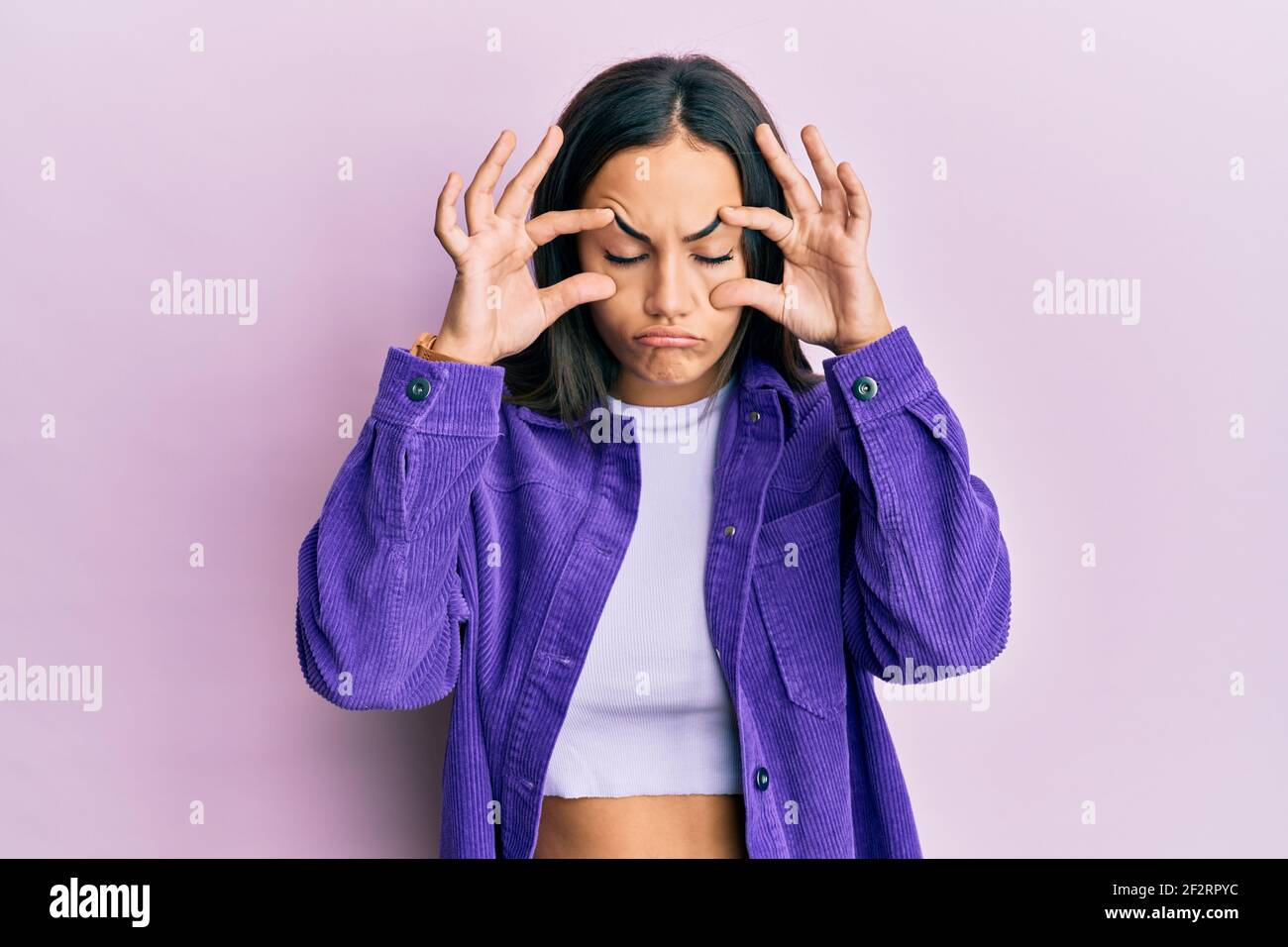 Young brunette woman wearing casual clothes trying to open eyes with ...