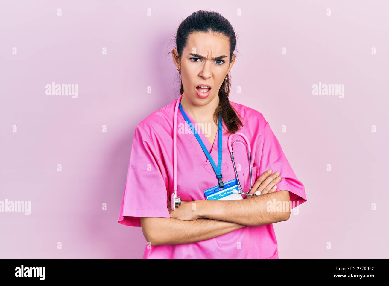 Young brunette woman wearing doctor uniform and stethoscope standing ...