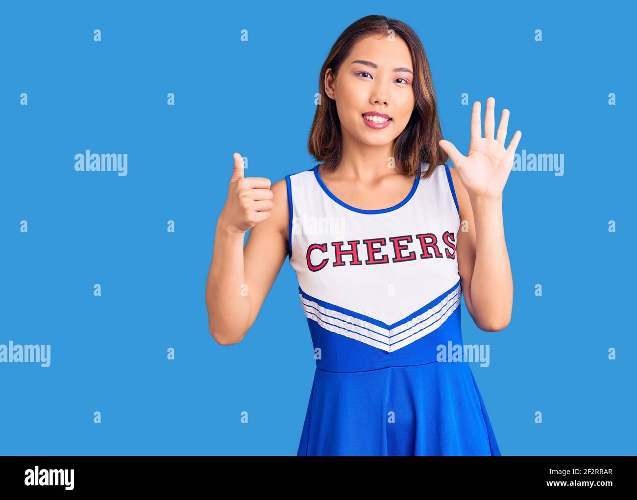 Young Beautiful Chinese Girl Wearing Cheerleader Uniform Showing And 4620