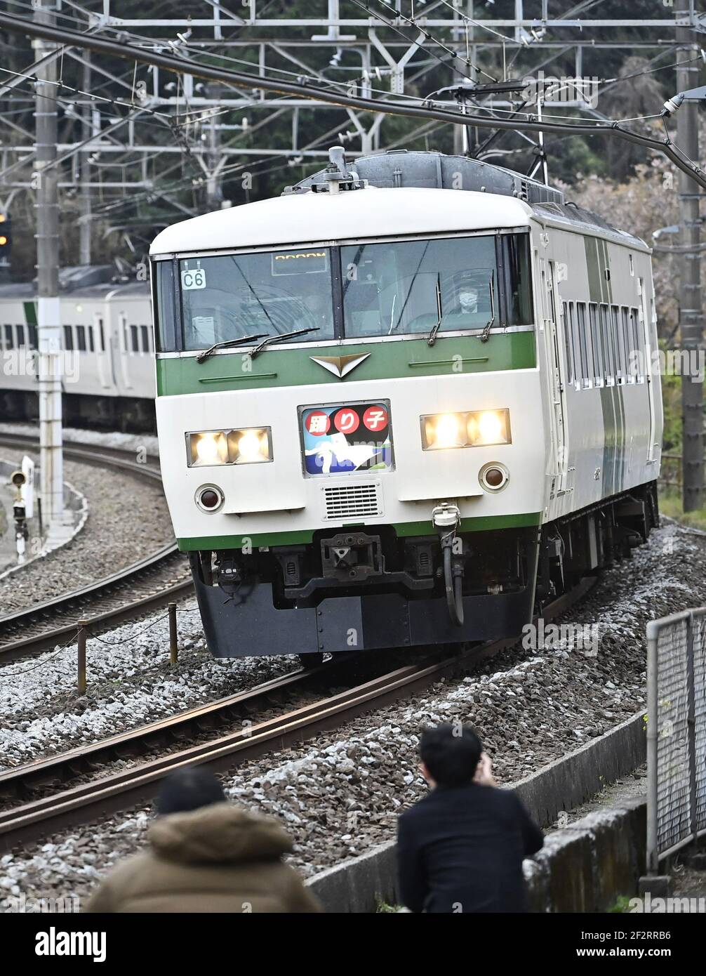 Railway fans wave to East Japan Railway Co.'s Memorial 185 train during ...