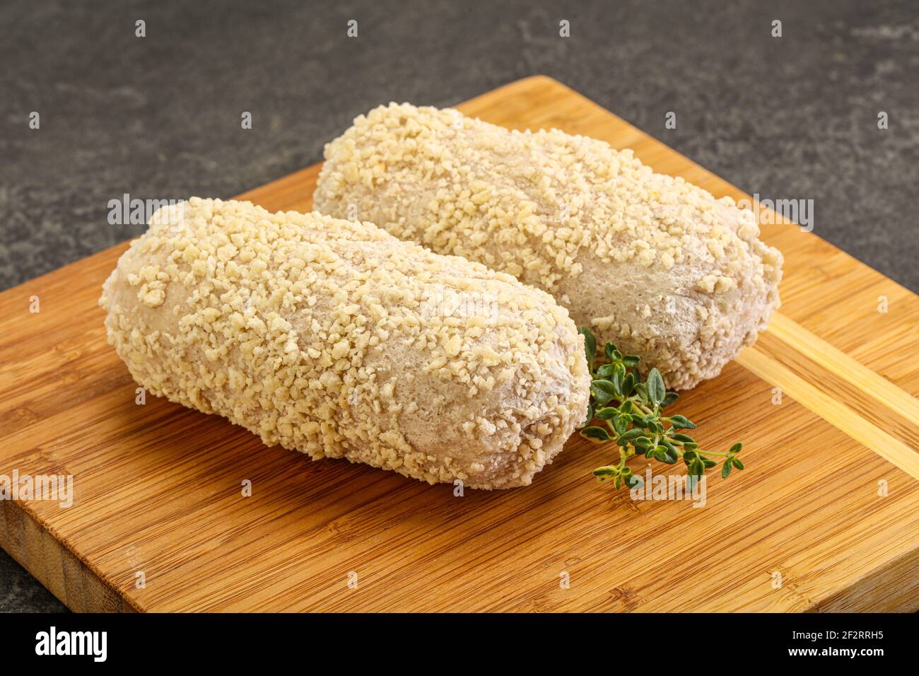 Raw breaded chicken cutlet for roast Stock Photo - Alamy