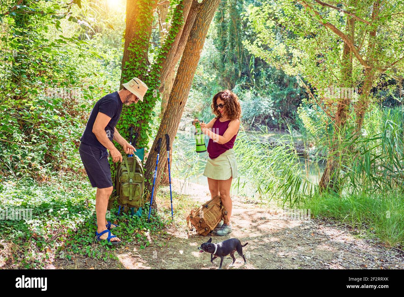 Beautiful couple of hiker wearing backpack doing trekking using hiking ...
