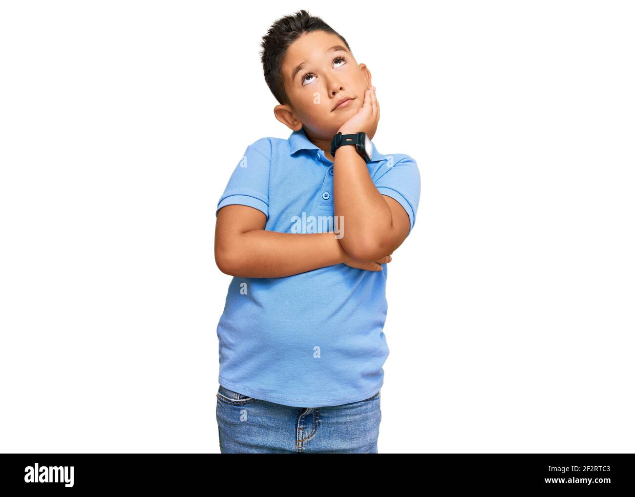 Little boy hispanic kid wearing casual clothes with hand on chin ...