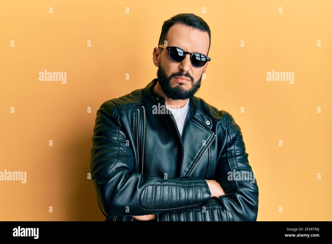 Young man with beard wearing black leather jacket and sunglasses ...