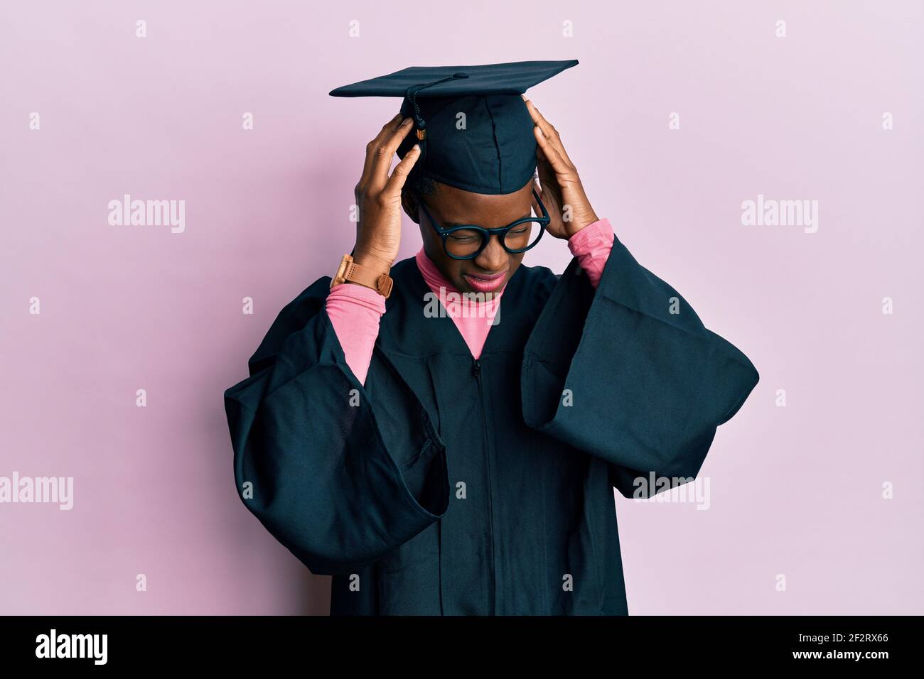Young african american girl wearing graduation cap and ceremony robe ...