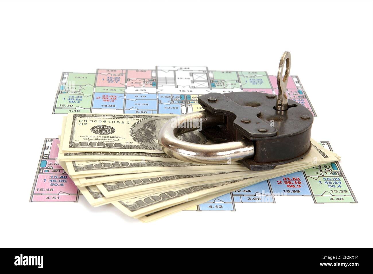 Hundred dollar bills money pile and the old castle on blueprints with ...