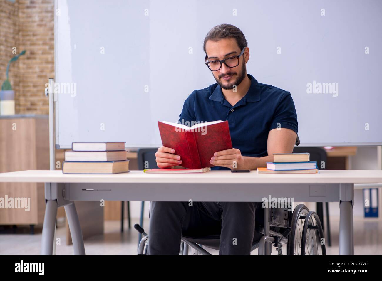 Young handicapped student in the classroom Stock Photo - Alamy
