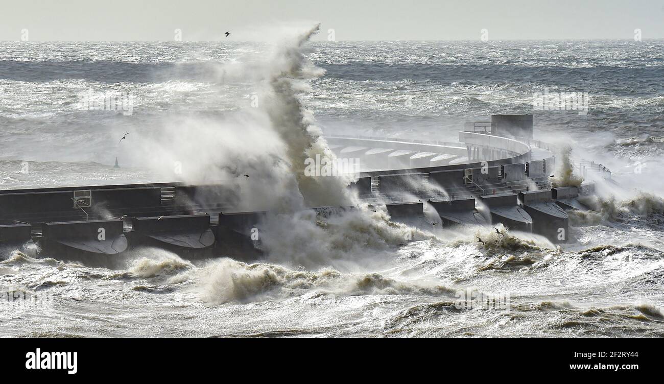Brighton UK 13th March 2021 - Waves crash over Brighton Marina as ...