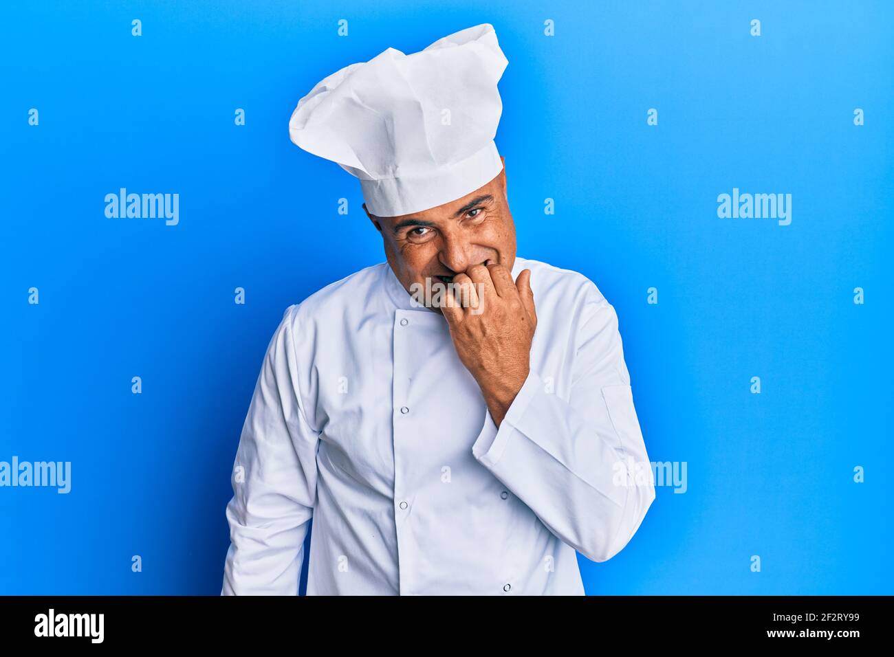 Mature middle east man wearing professional cook uniform and hat ...