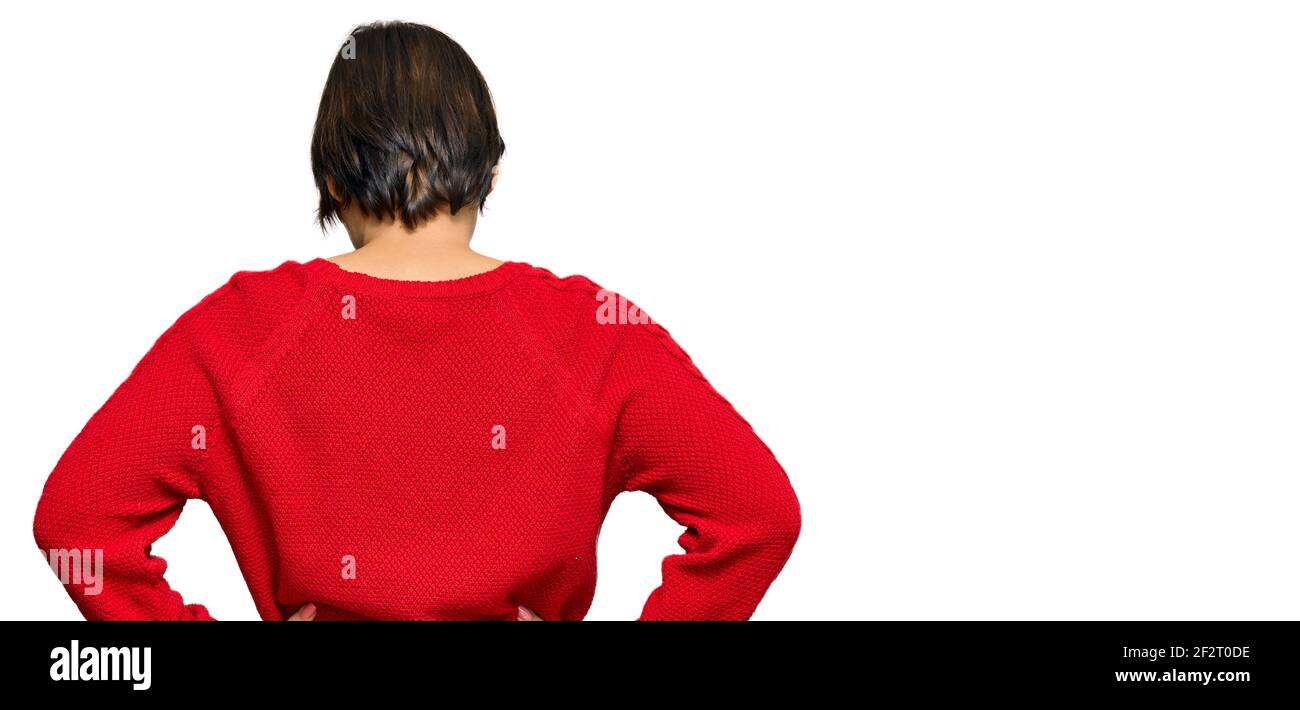 Young beautiful hispanic woman with short hair wearing casual sweater ...
