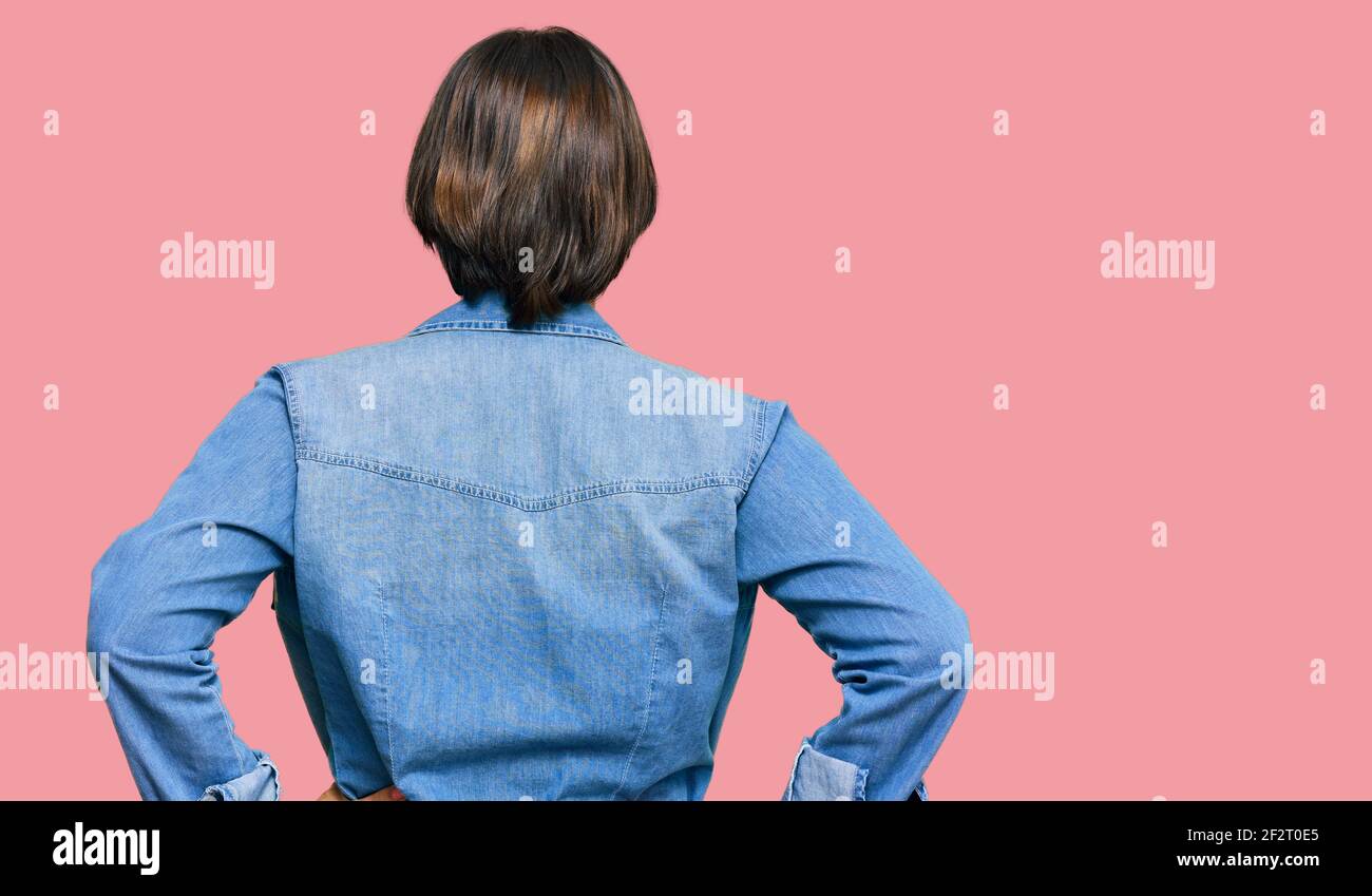 Young beautiful hispanic woman with short hair wearing casual denim ...