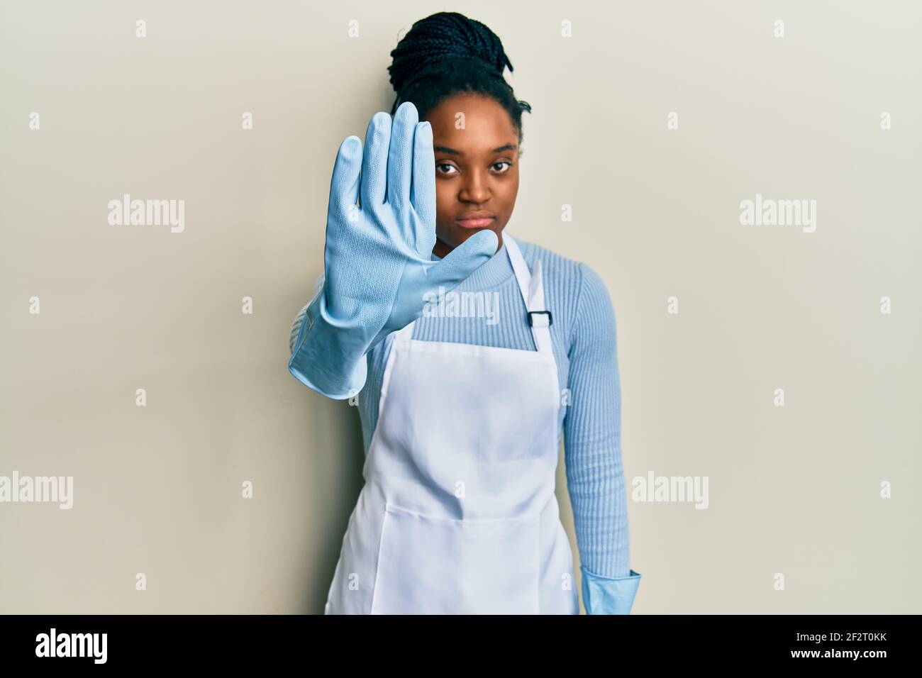 African american woman with braided hair wearing cleaner apron and ...