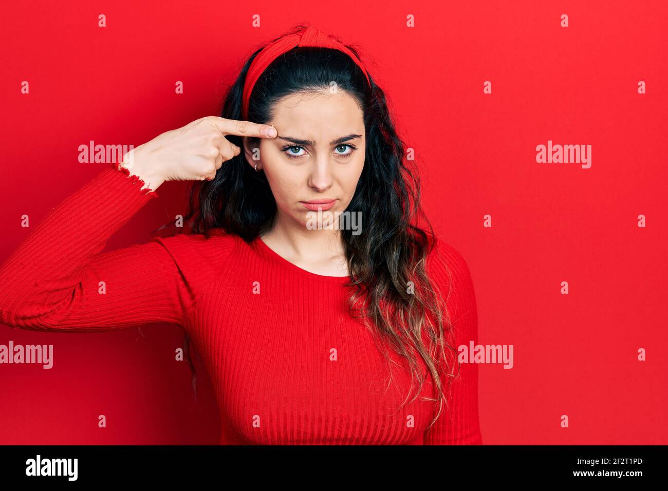 Young hispanic woman wearing casual clothes pointing unhappy to pimple ...