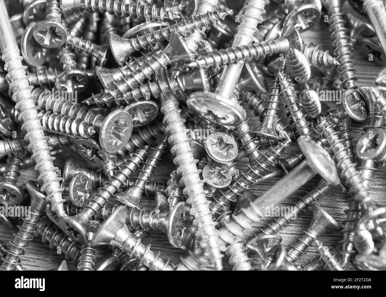 Oxidised screws, chrome-plated screws, brass-plated screws, a pile of ...