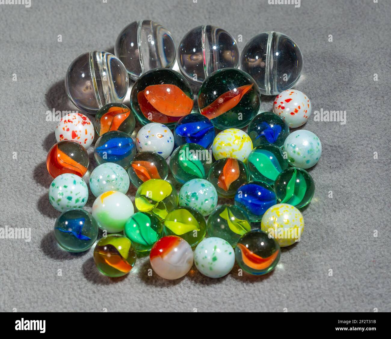 collection of various types and sizes of marbles grouped together Stock ...