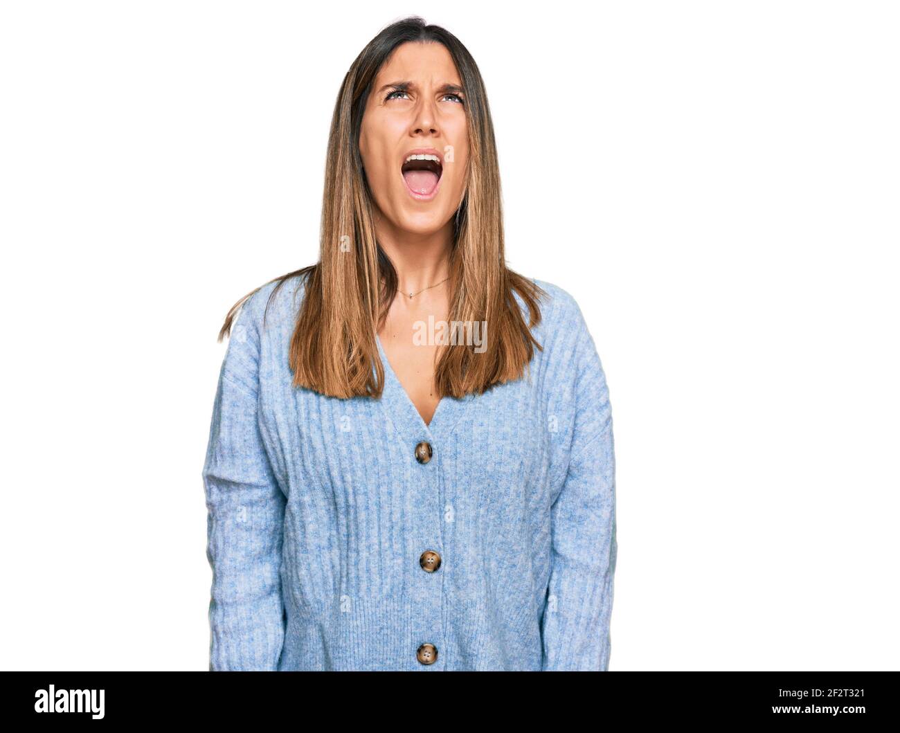 Young woman wearing casual clothes angry and mad screaming frustrated ...
