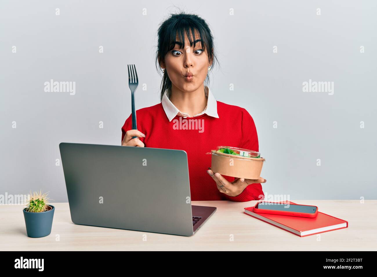 Woman and comical expression and eating hi-res stock photography and ...