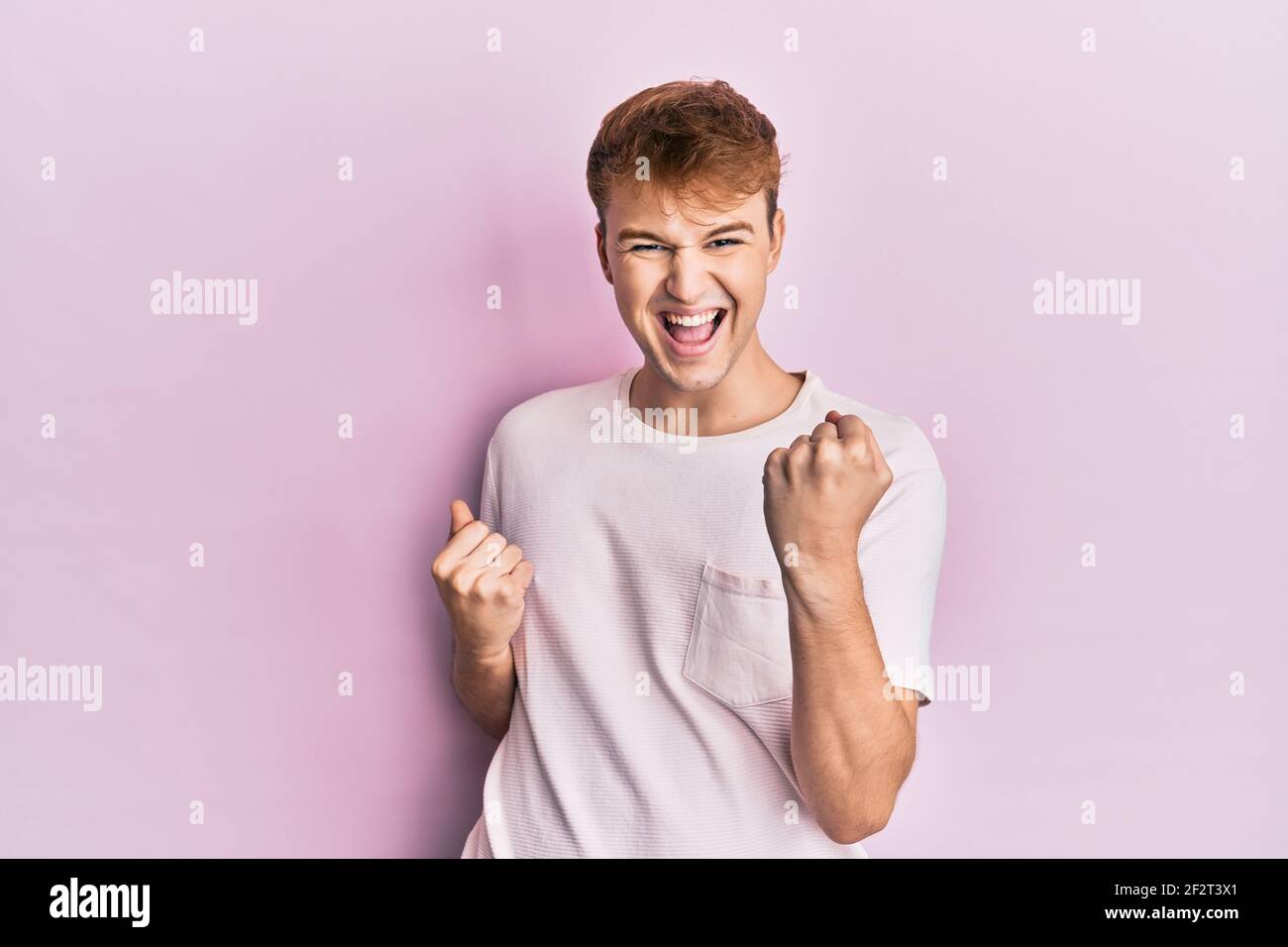 Young caucasian man wearing casual t shirt celebrating surprised and ...