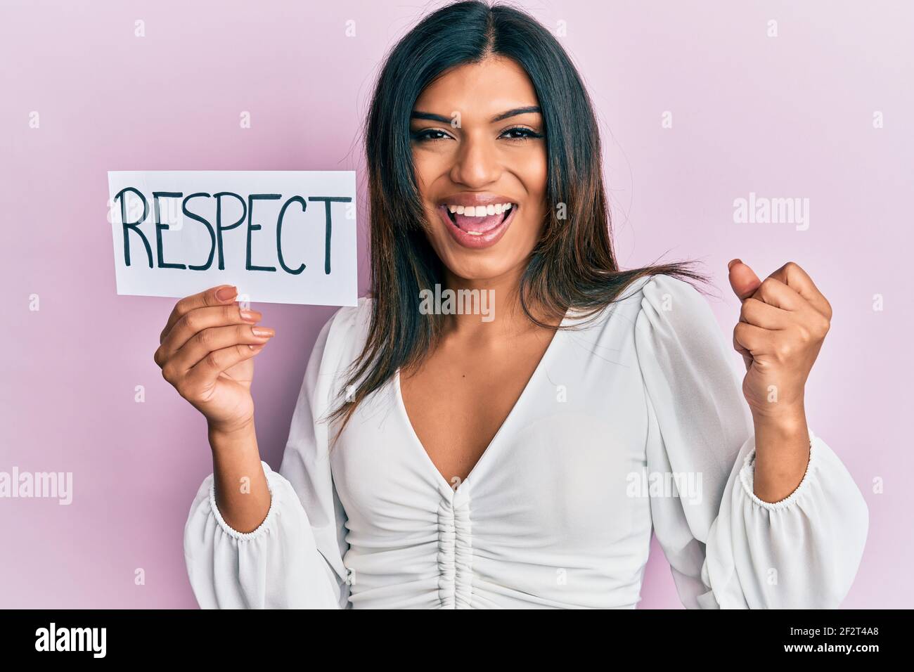 Young latin transsexual transgender woman holding respect message paper ...