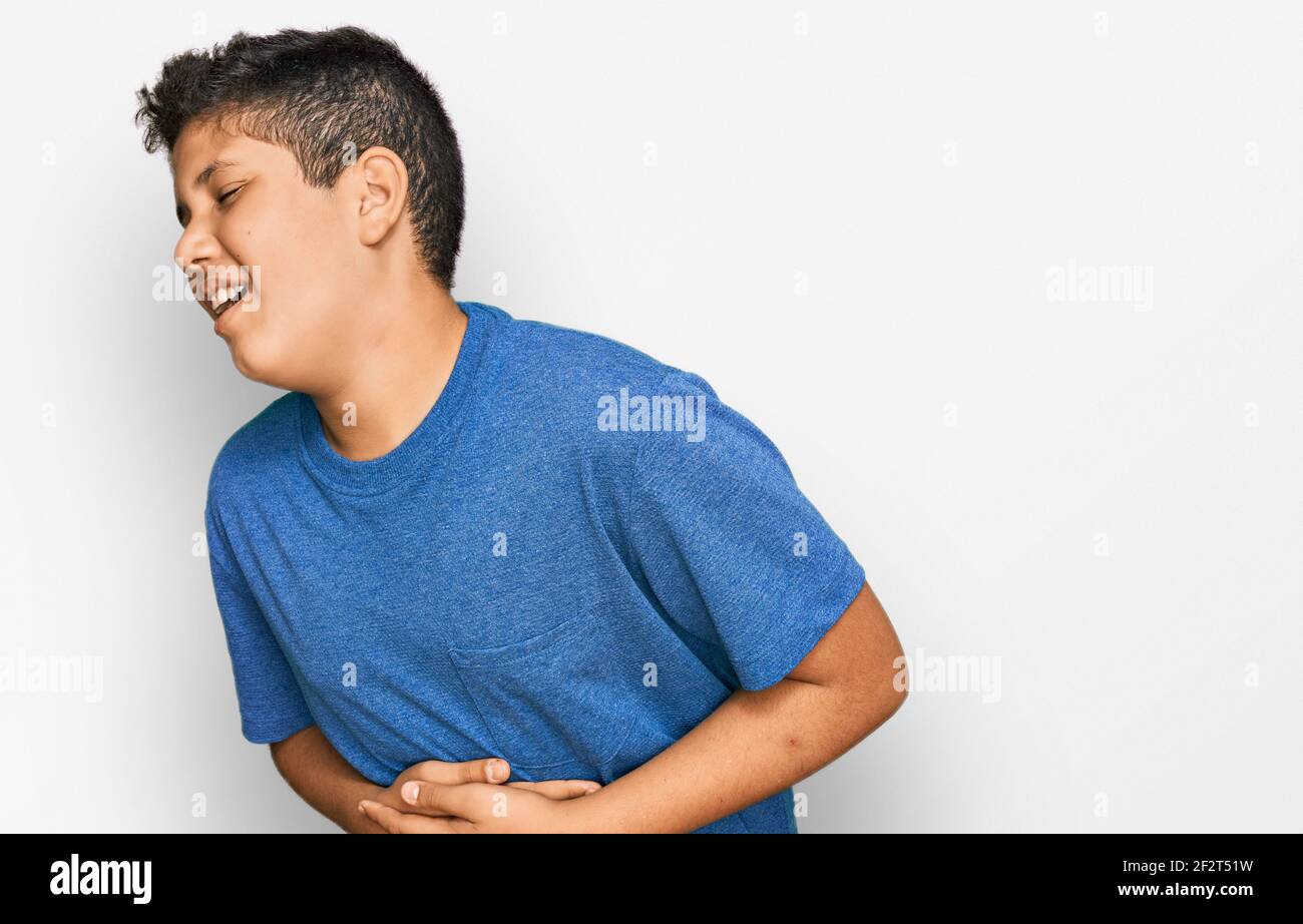 Teenager hispanic boy wearing casual clothes with hand on stomach ...