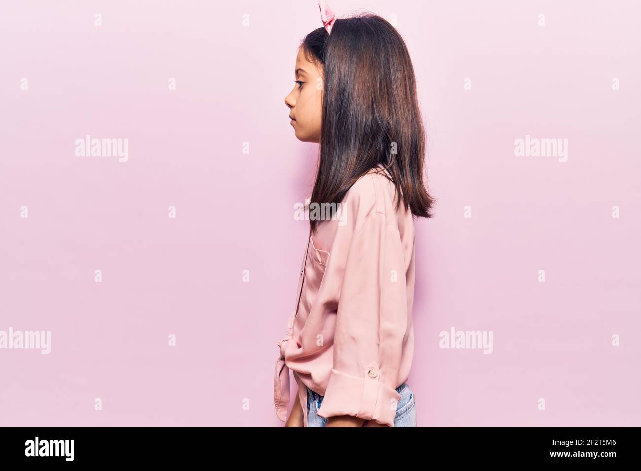 Beautiful child girl wearing casual clothes looking to side, relax ...